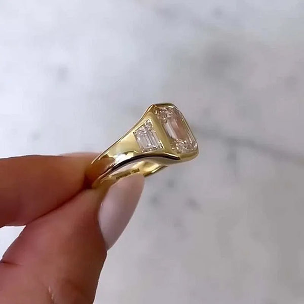 4.5ct three stone emerald cut all over bezel set yellow gold engagemen