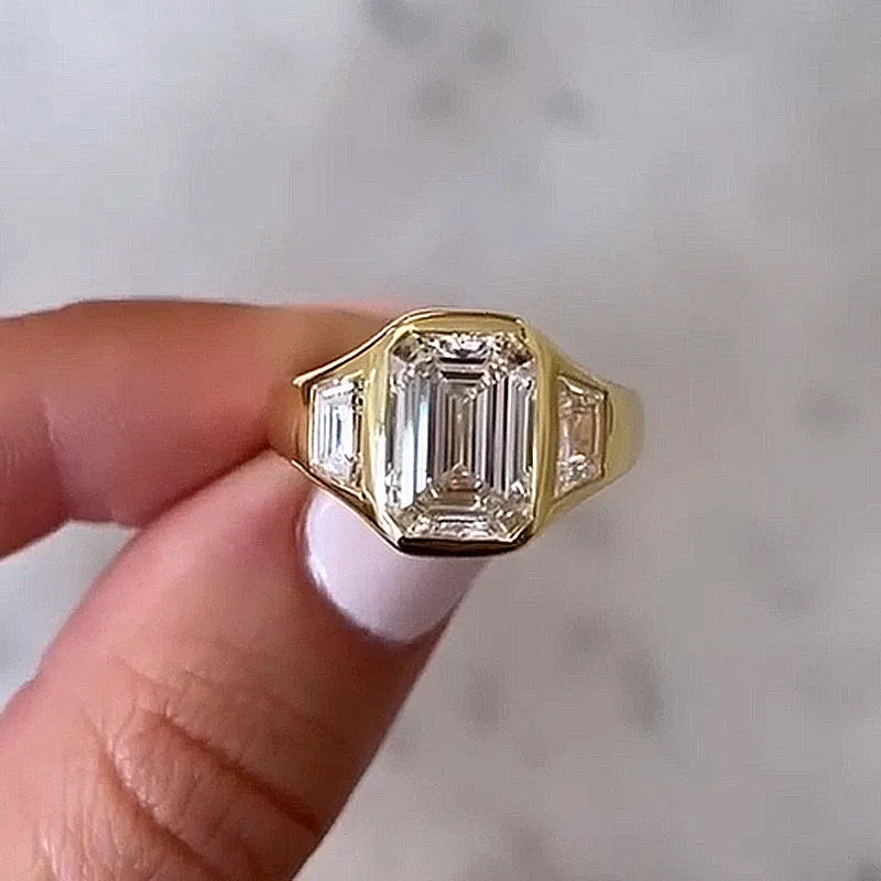 4.5ct three stone emerald cut all over bezel set yellow gold engagemen